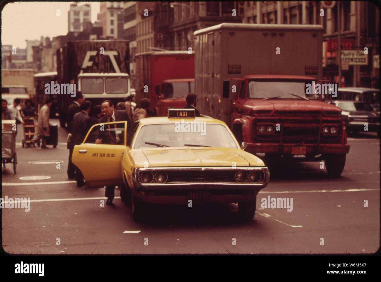TAKING ON A FARE, CAB BLOCKS TRAFFIC IN MIDTOWN MANHATTAN Stock Photo ...