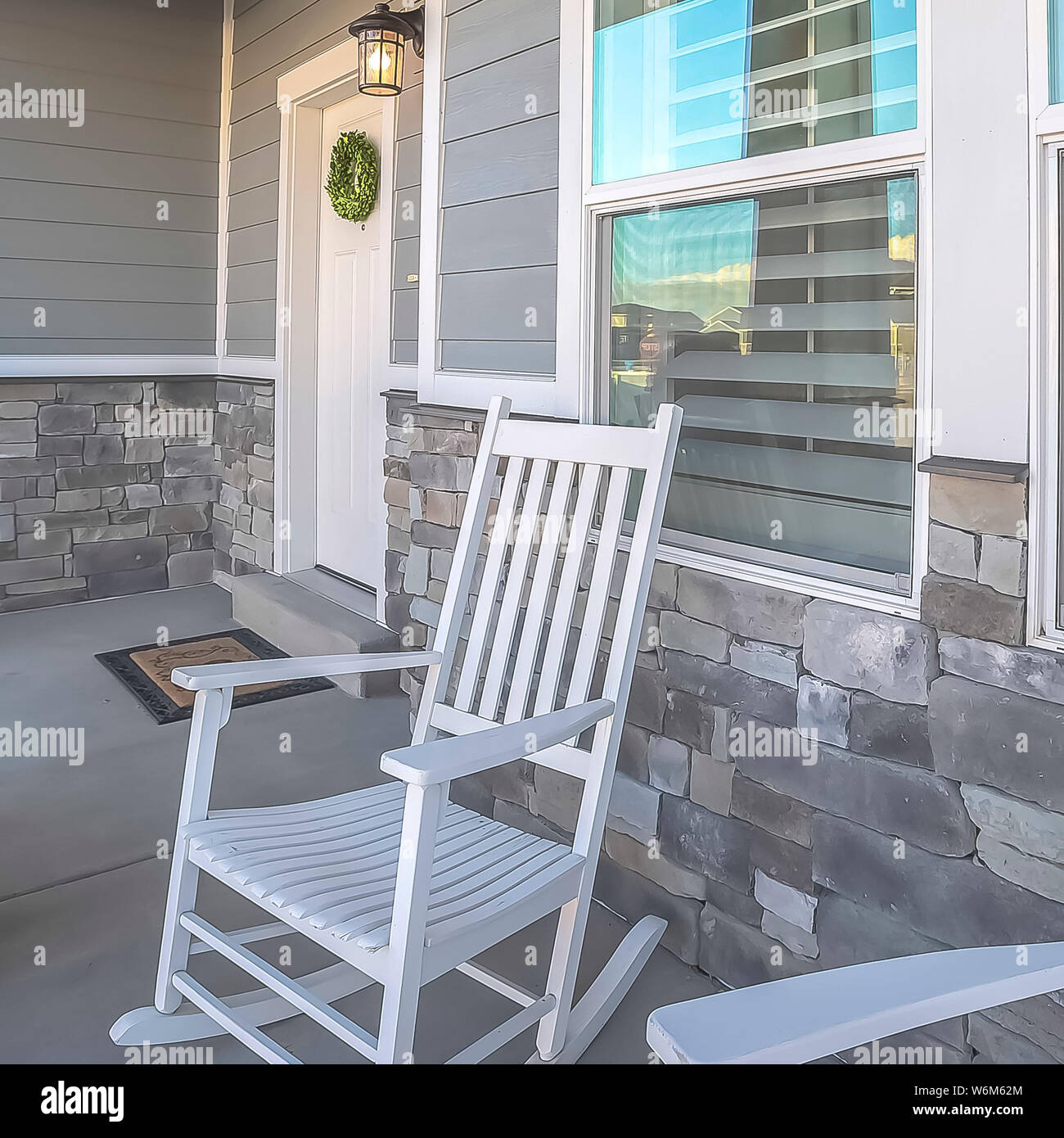 Square frame Porch with rocking chairs and door with wreath viewed at ...