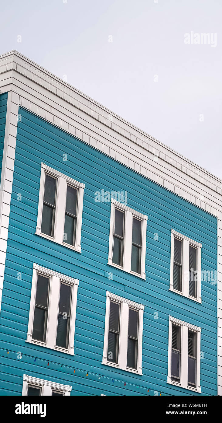 Vertical Residential building with blue exterior wall and vertical ...
