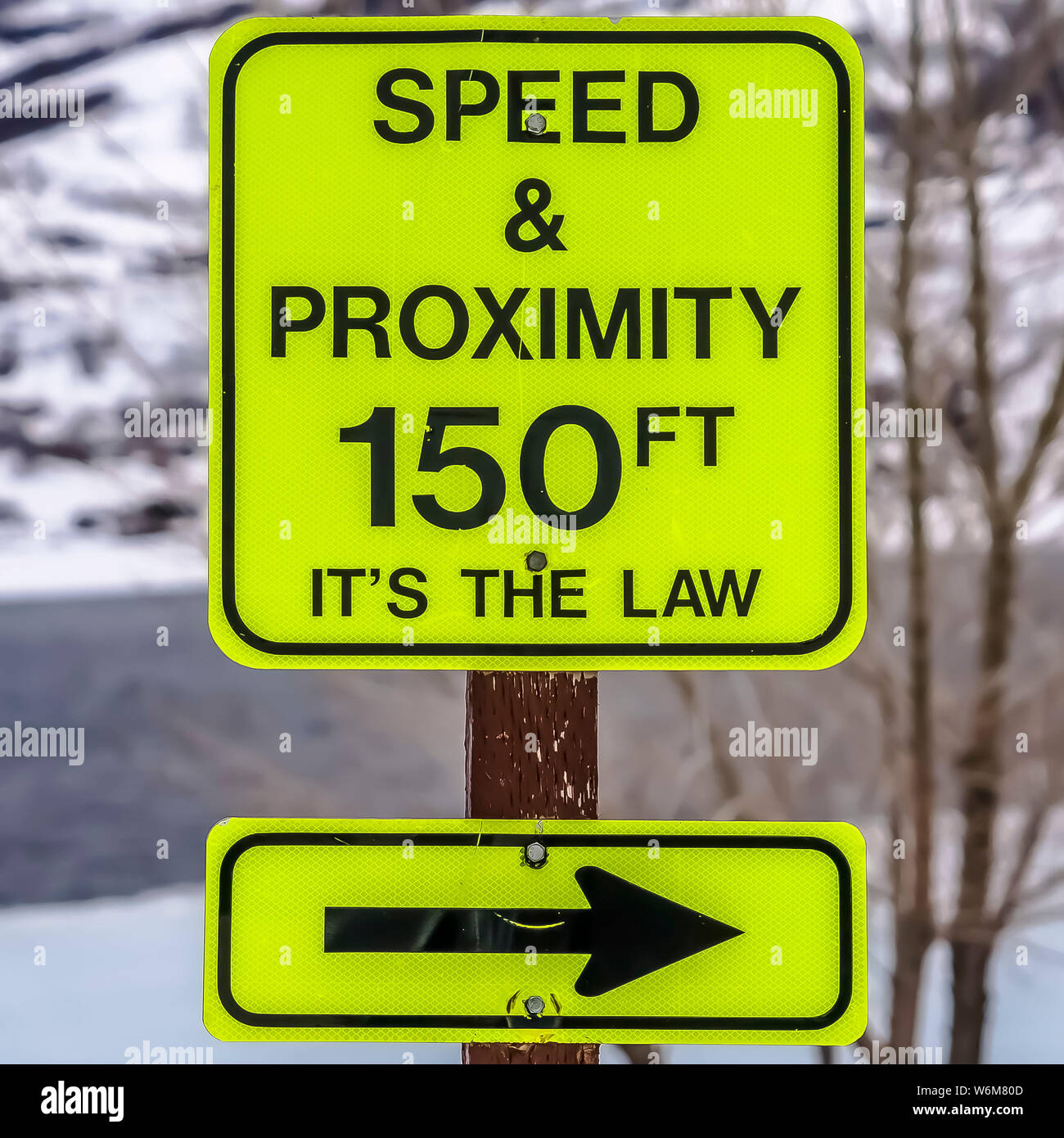Square Speed and Proximity road sign against a snow covered mountain in ...