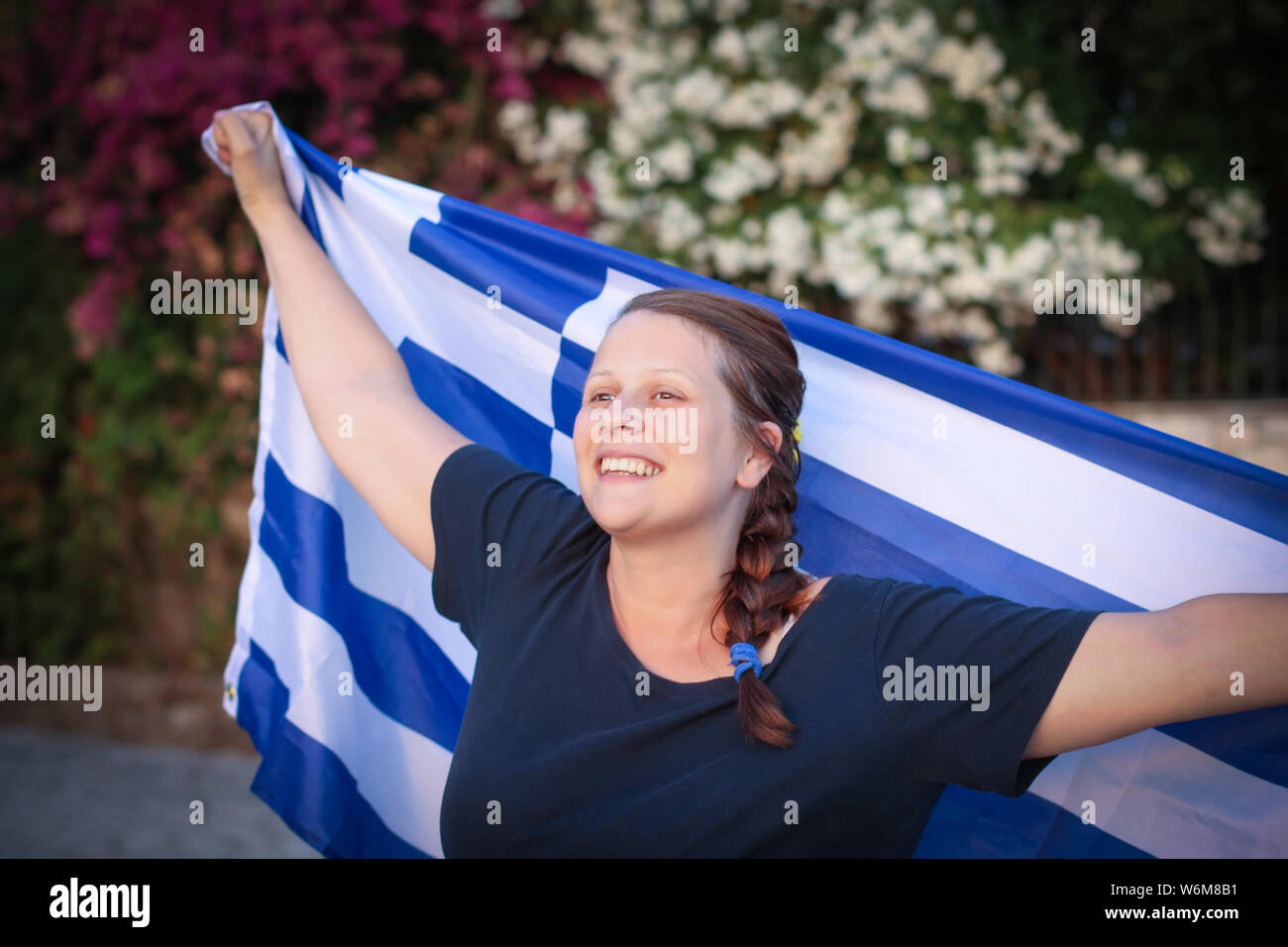 Happy Woman Holding A Greek Flag Stock Photo - Alamy
