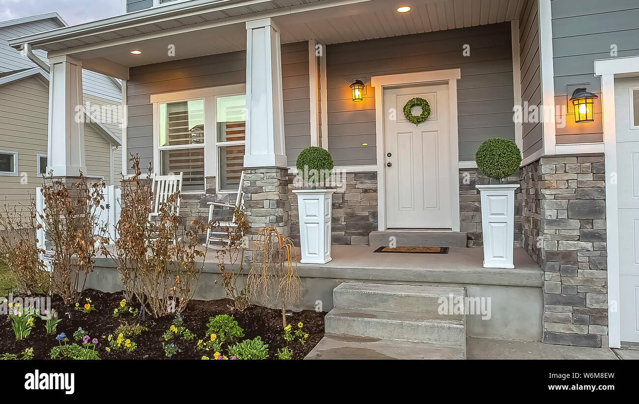 Panorama Porch and yard at the facade of a home with stairs leading to ...