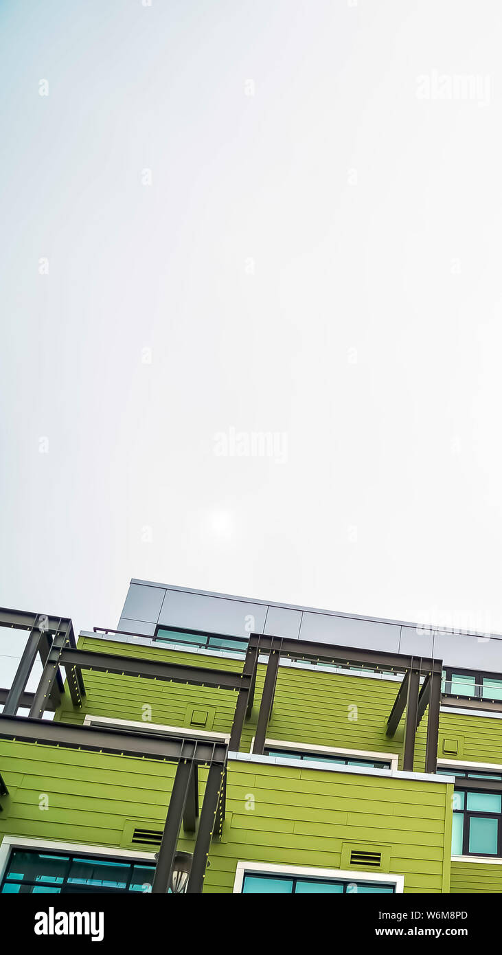 Vertical Exterior of a residential building with green horizontal ...