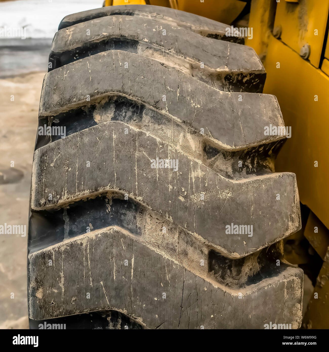 Square Close up of black rubber wheel with diagonal tread of a ...