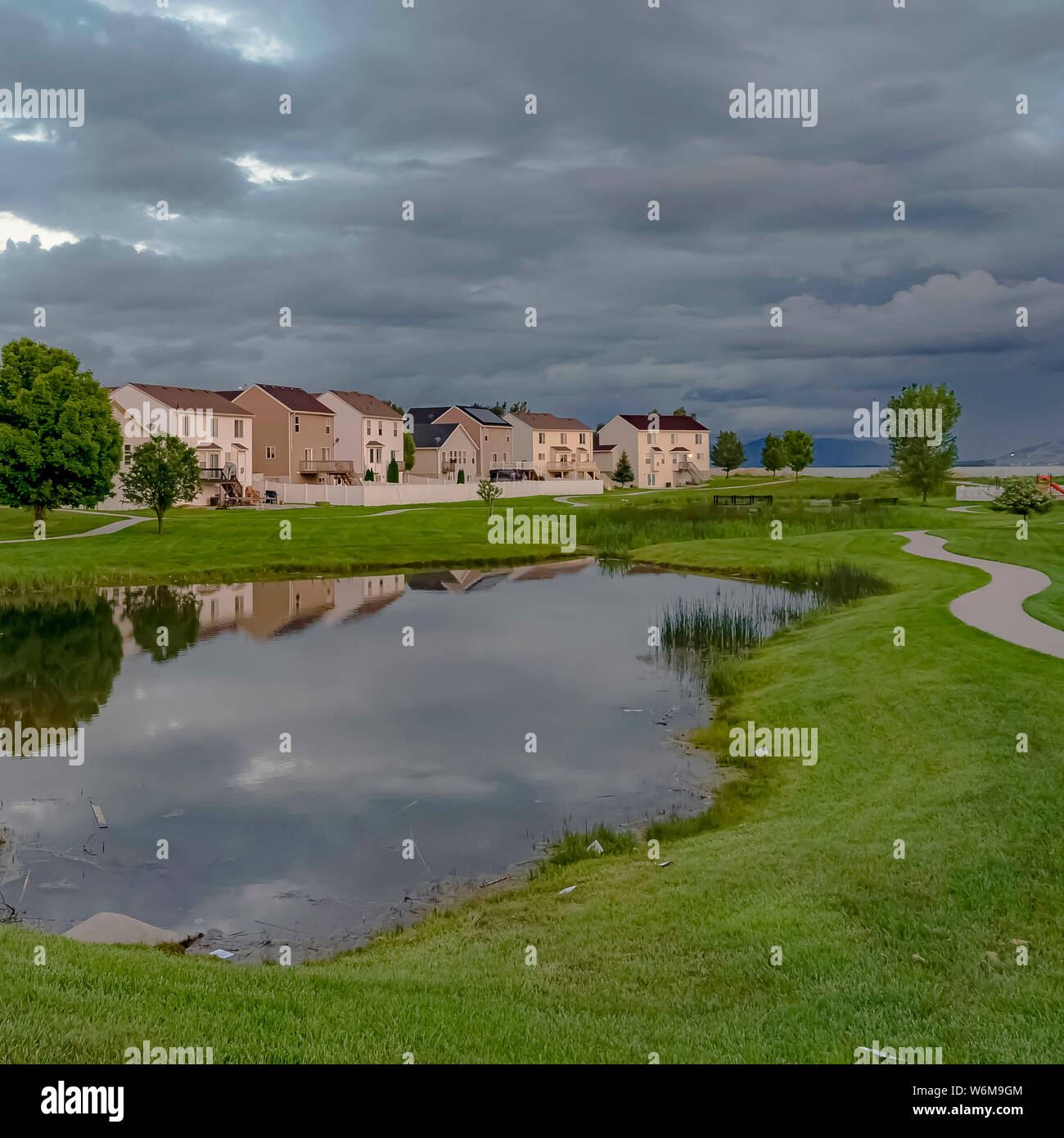 Square frame Scenic neighborhood park with a shiny pond and pathway ...