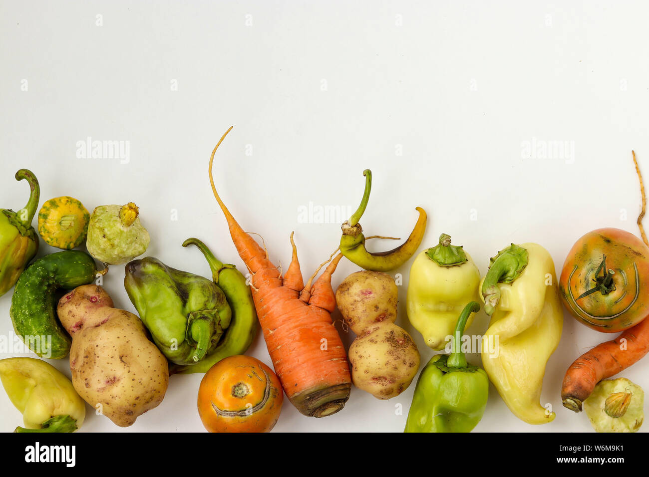 Ugly vegetables: potatoes, carrots, cucumber, peppers and tomatoes on ...