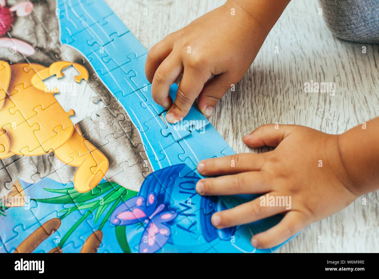 Boy learning how to solve a puzzle Stock Photo - Alamy