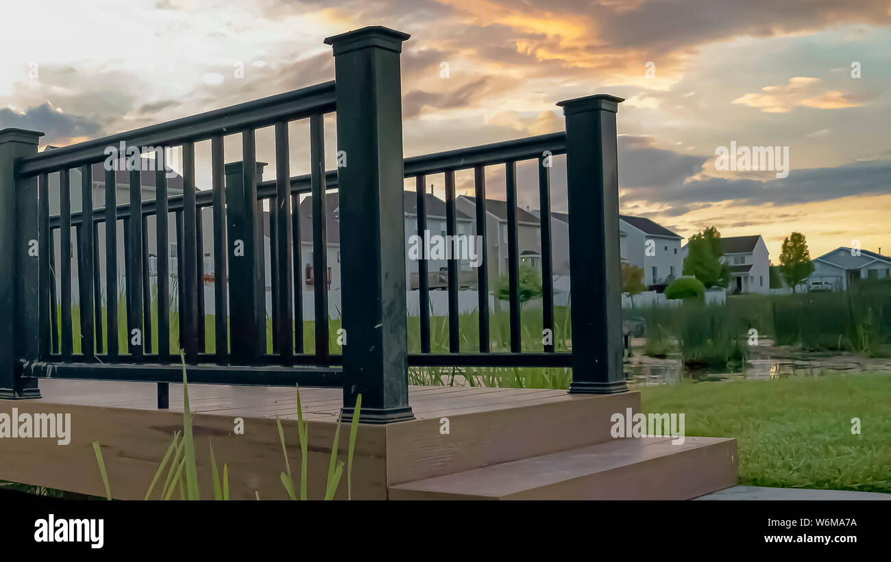 Panorama Bridge with wooden deck and black guardrail over a small and ...