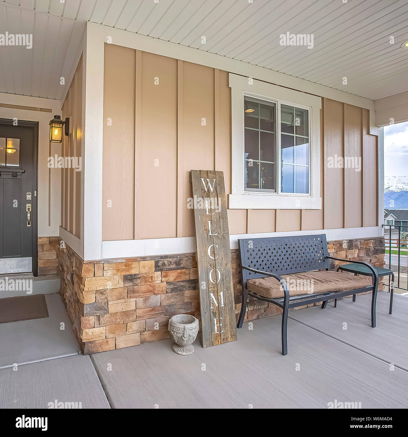 Square House exterior with porch and glass paned wooden front door ...