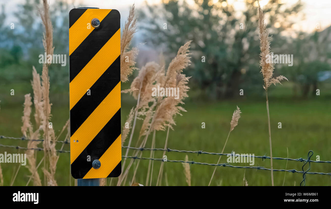 Panorama frame Close up of black and yellow diagonal stripes road sign ...