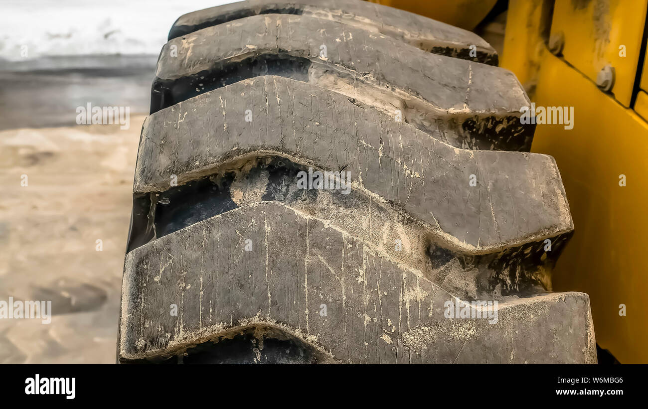 Panorama frame Close up of black rubber wheel with diagonal tread of a ...