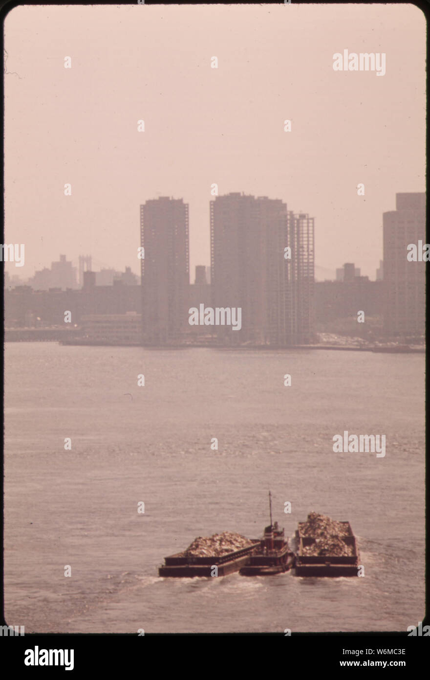 TUGBOAT TOWS GARBAGE SCOWS DOWN THE EAST RIVER DESTINATION IS THE ...