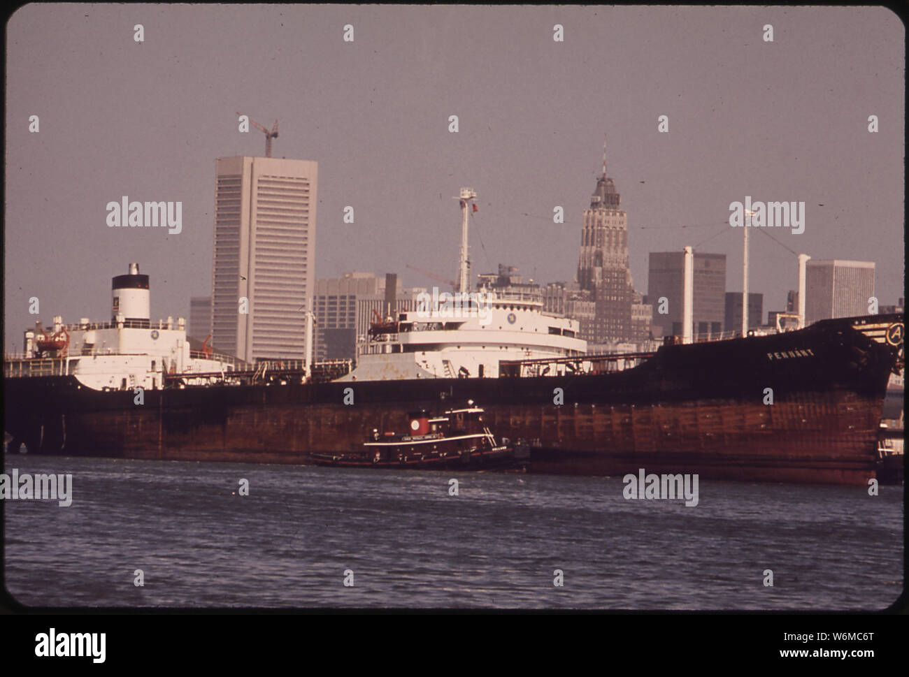 TUGBOATS HELP MOVE A CARGO SHIP OUT OF THE BALTIMORE HARBOR THROUGH THE ...