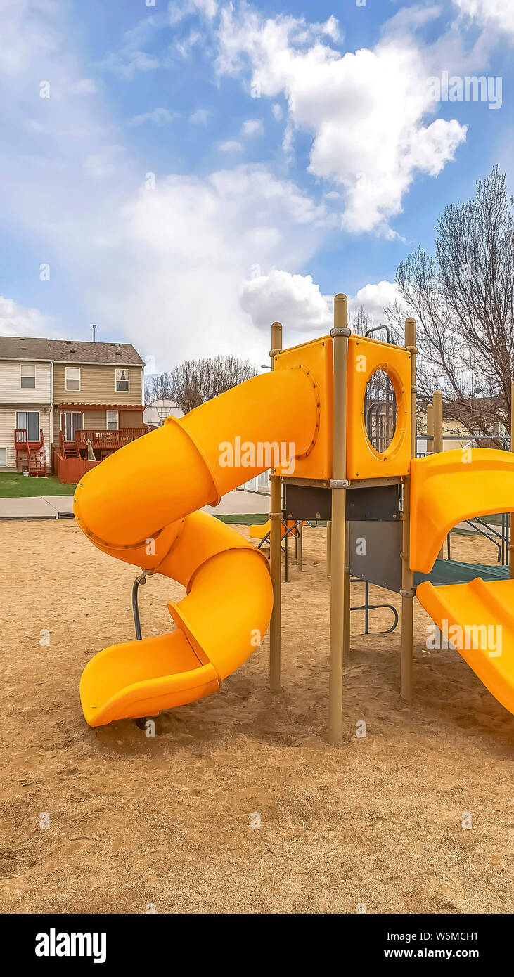 Vertical Playground in the middle of houses and roads under blue sky ...