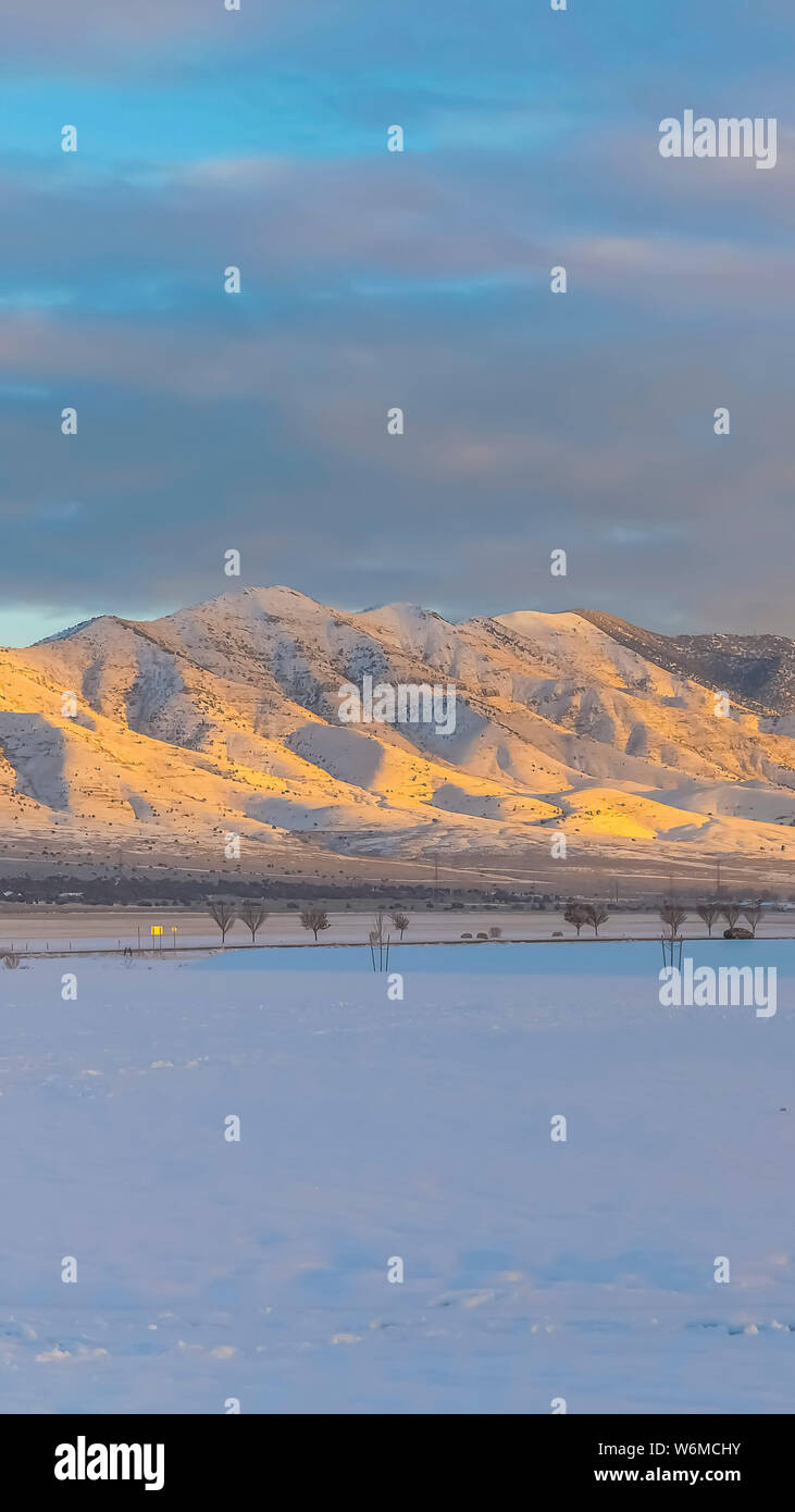 Vertical frame Vast terrain and towering mountain covered with snow on ...