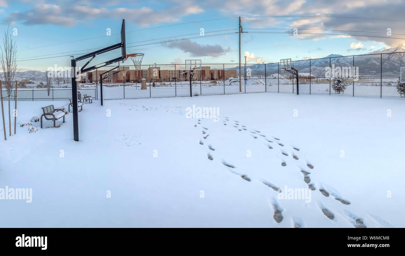 Panorama Basketball court on a park with view of distant snowy mountain ...