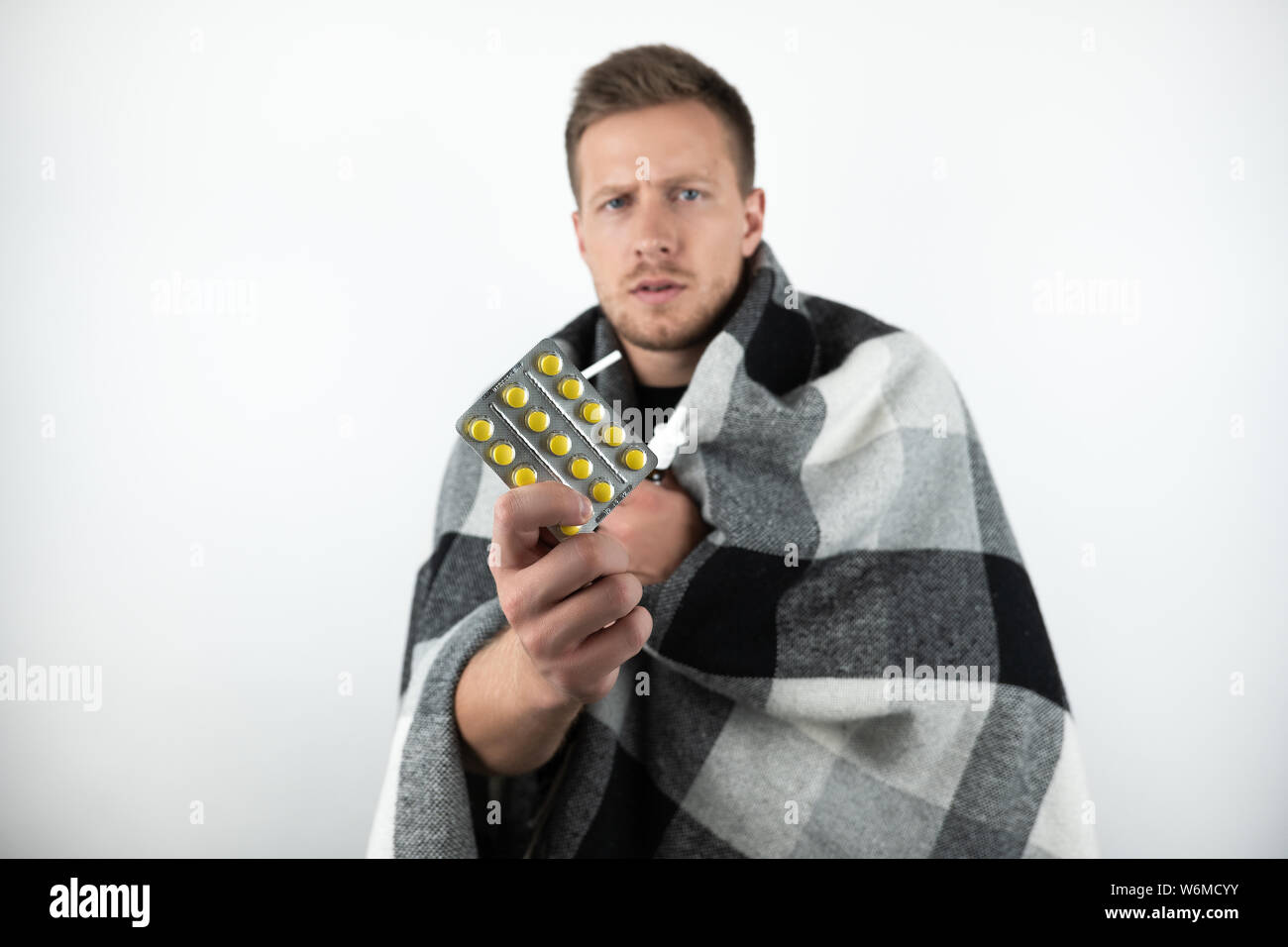 handsome young sick man wrapped checkered plaid holds pills and nasal ...