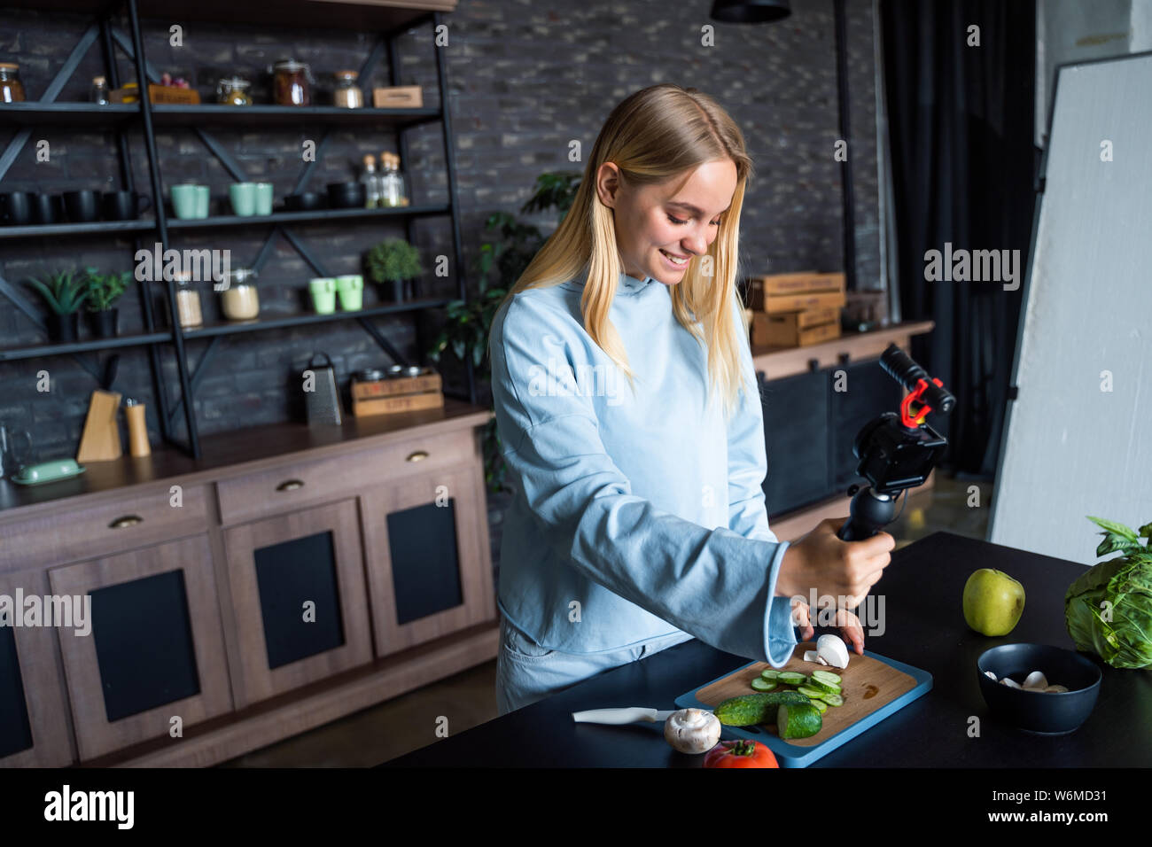 Beautiful young girl posing in the kitchen Stock Photo - Alamy