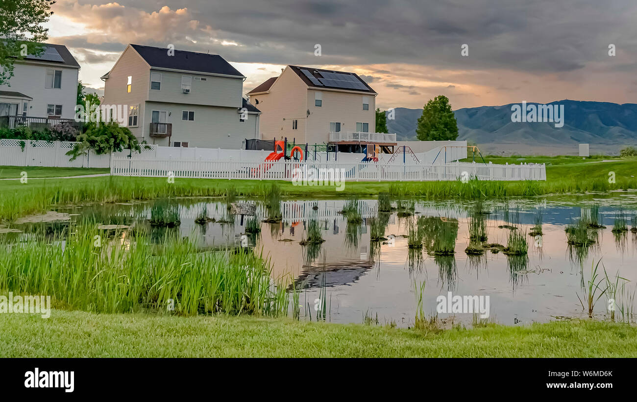 frame Shiny pond playground and multi storey homes surrounded by vast ...