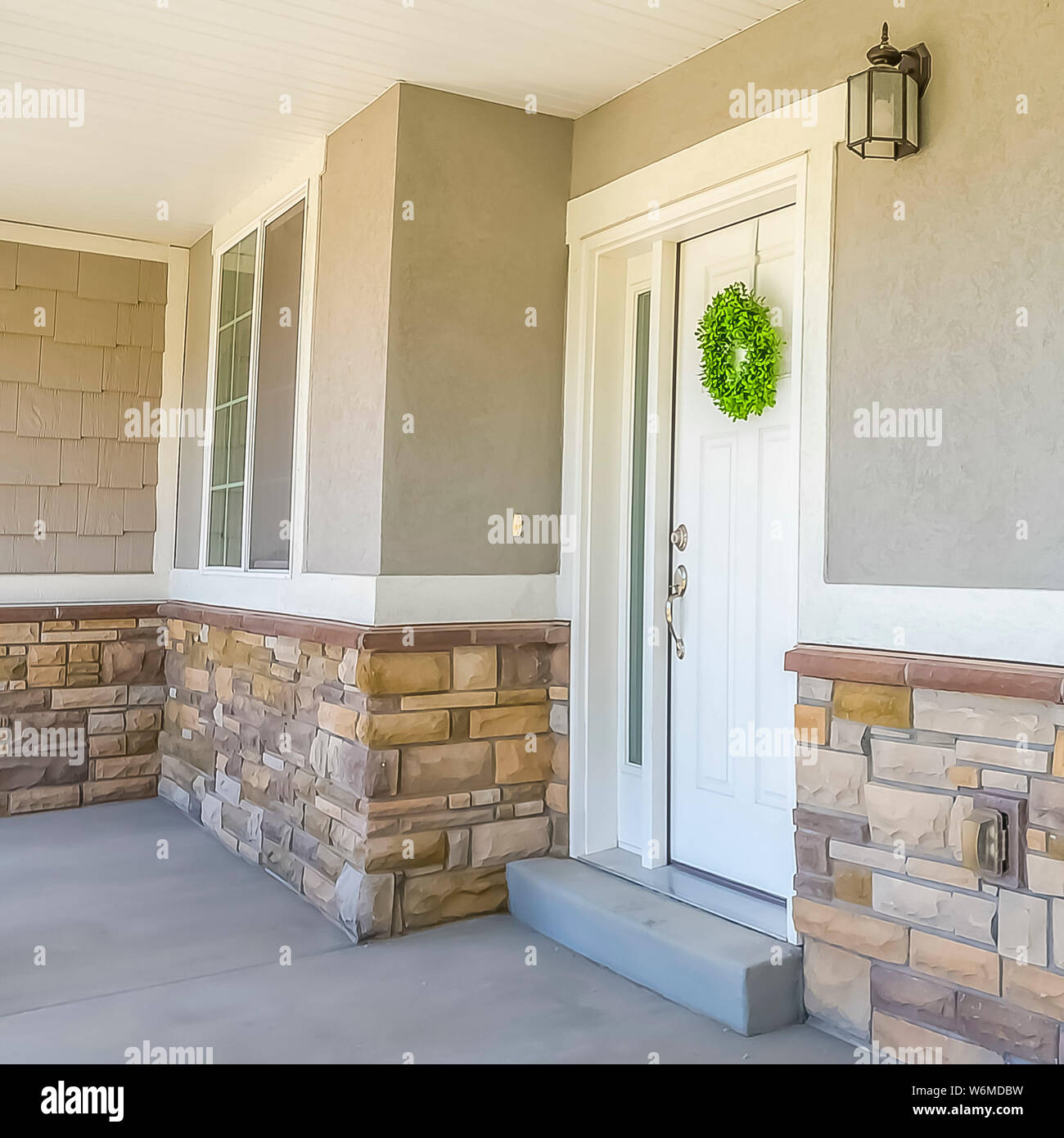 Square frame Porch of a home with a combination of concrete and stone ...