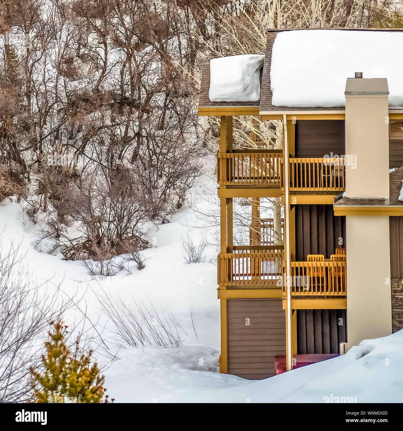 Square frame Balconies and chimney of homes against mountain covered ...