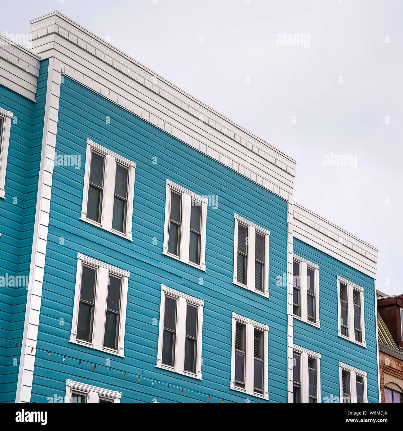 Square Residential building with blue exterior wall and vertical ...