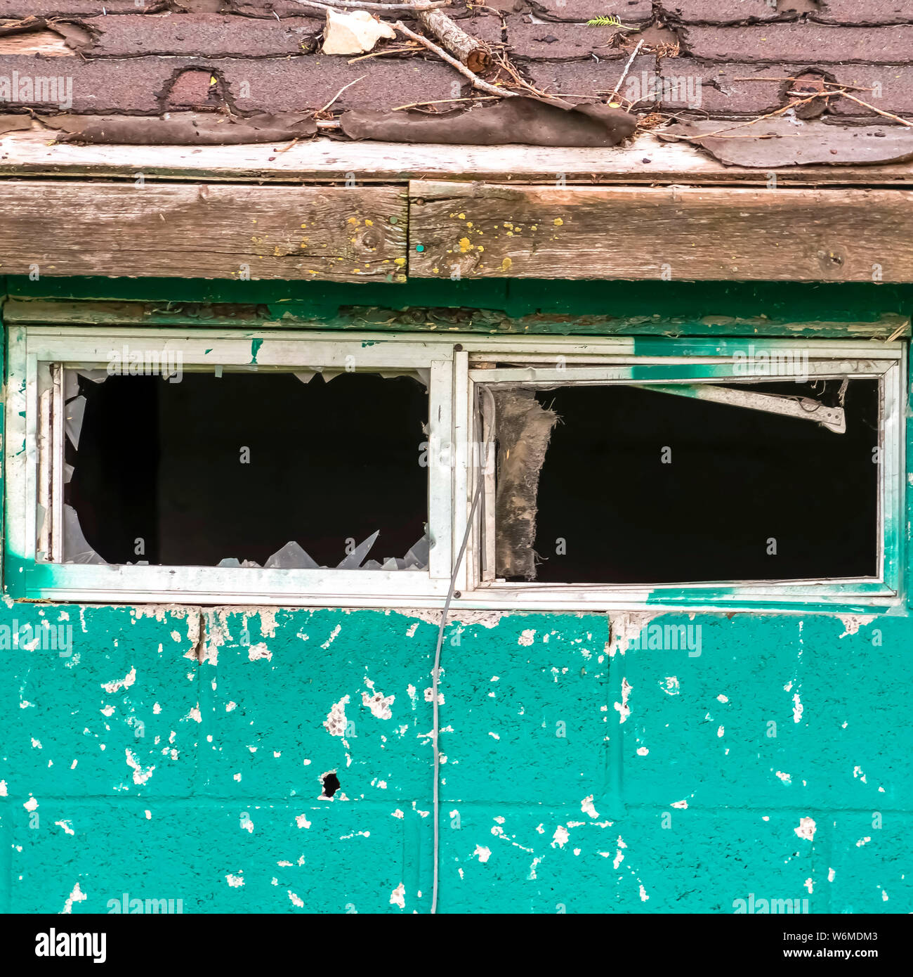 Square frame Close up of the small window with broken glass of an old ...