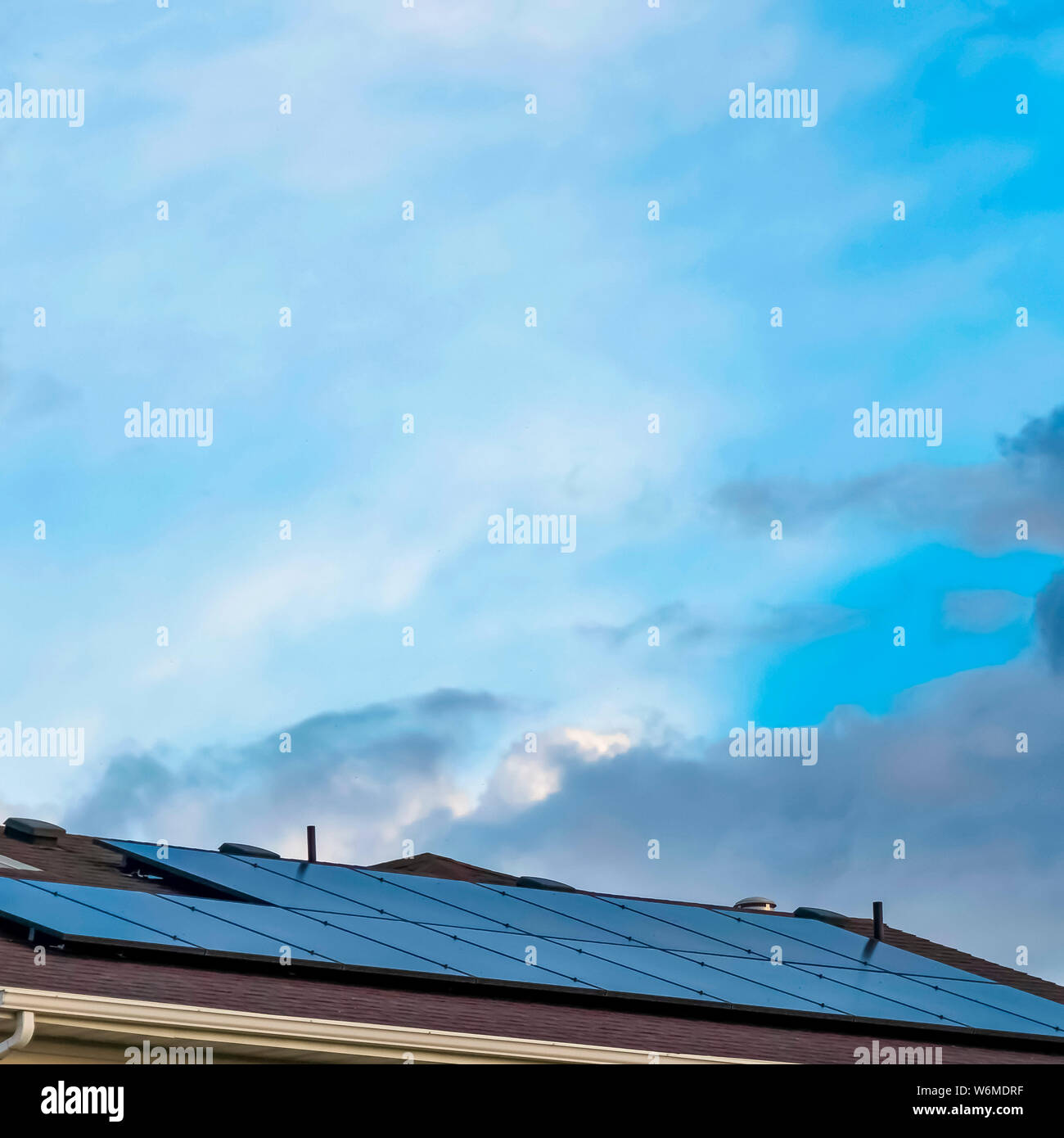 Square Solar panels installed on the roof of a home with white ...