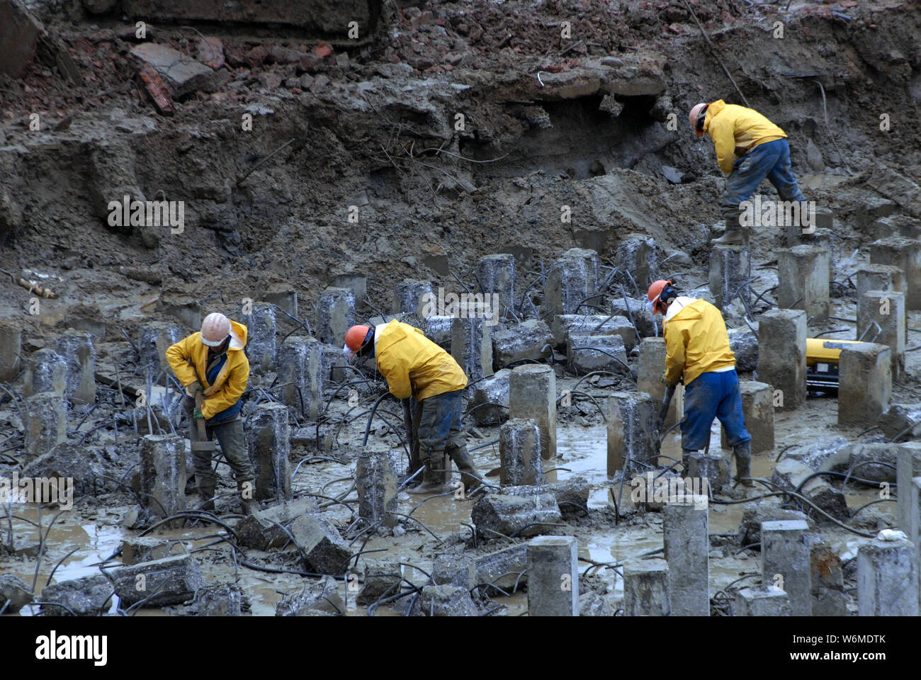 Group of jackhammer workers in a building foundation pit Stock Photo ...