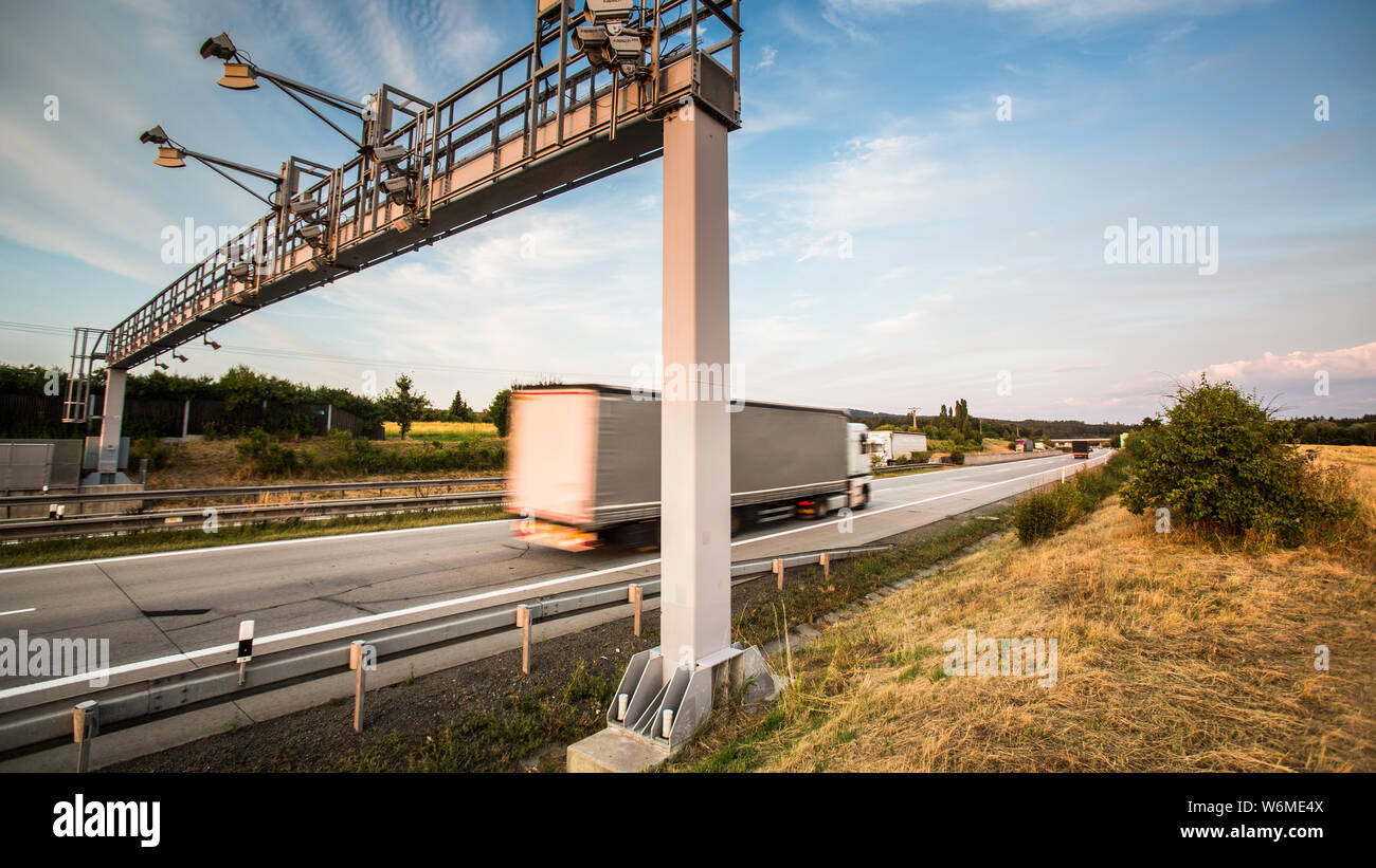 truck passing through a toll gate on a highway (motion blurred image ...