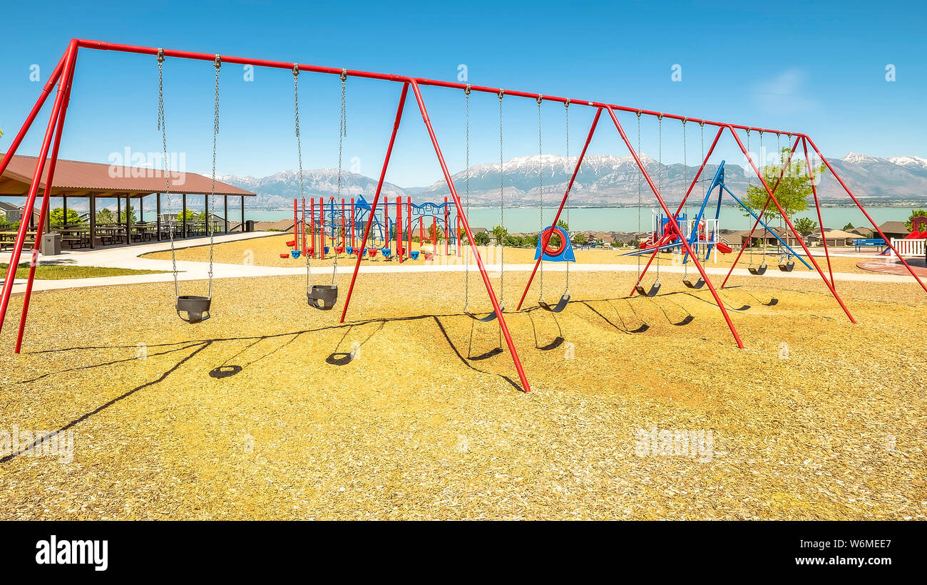 frame Park with swings and pavilions and scenic view of lake and snow ...