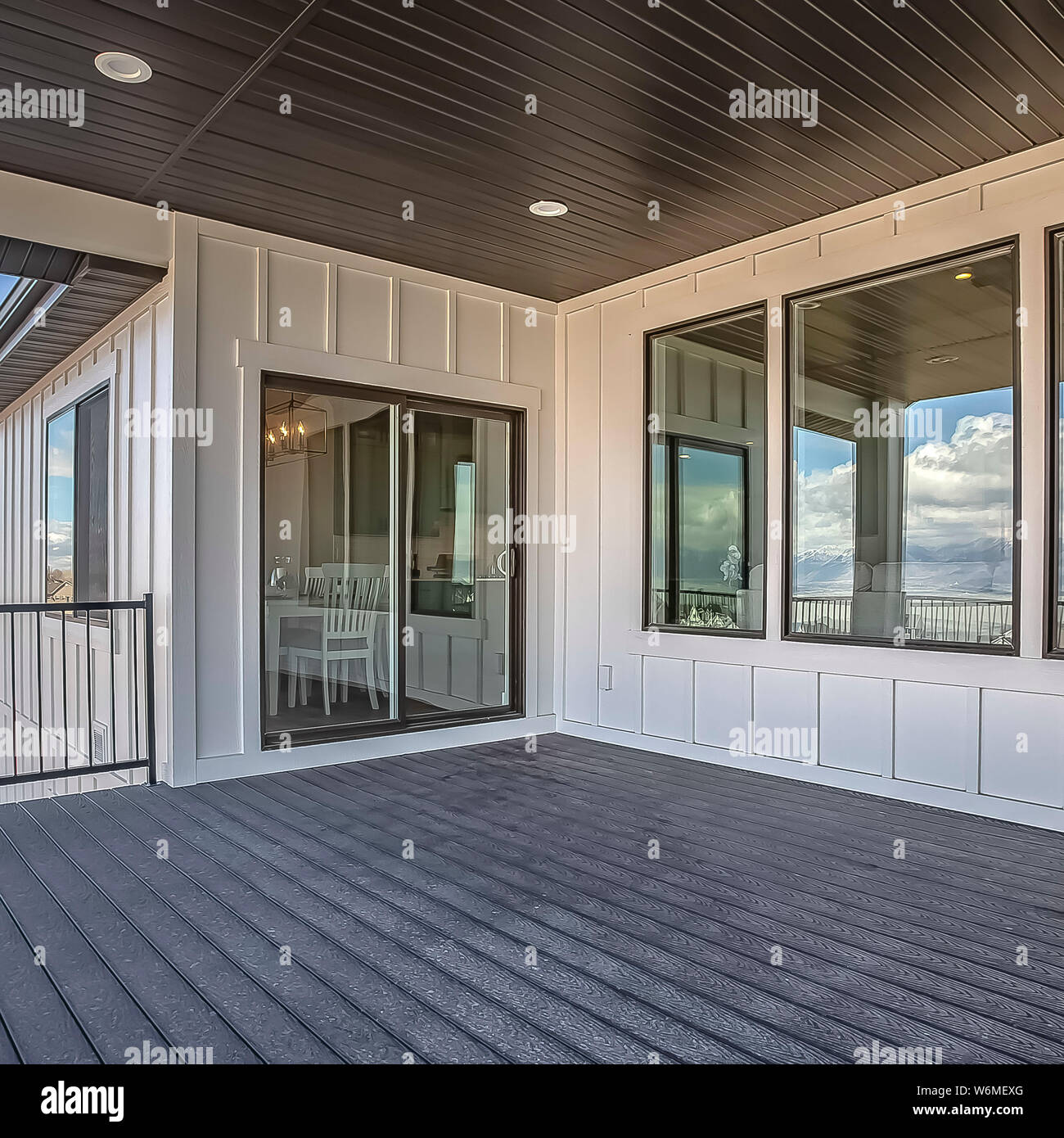 Square Spacious balcony of home with white wall and round lights on the ...