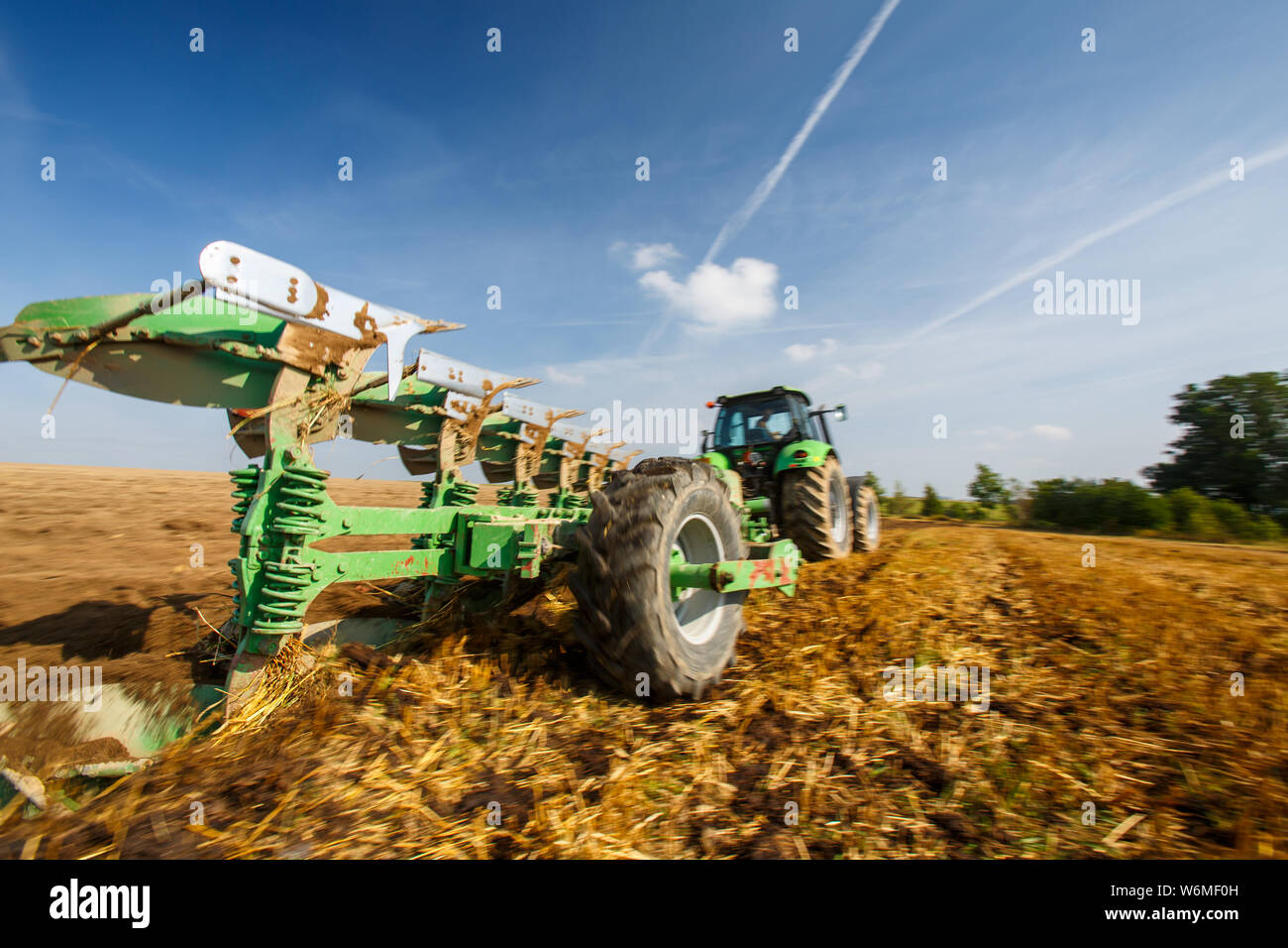 Tractor working on the farm, modern agricultural transport, farmer ...