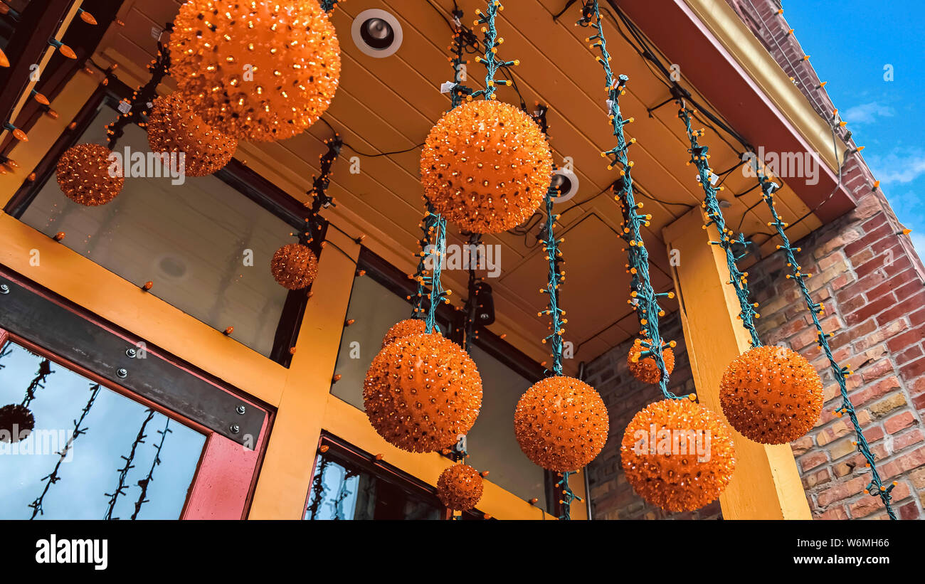 Panorama Orange light balls hanging at the entrance of a building with ...
