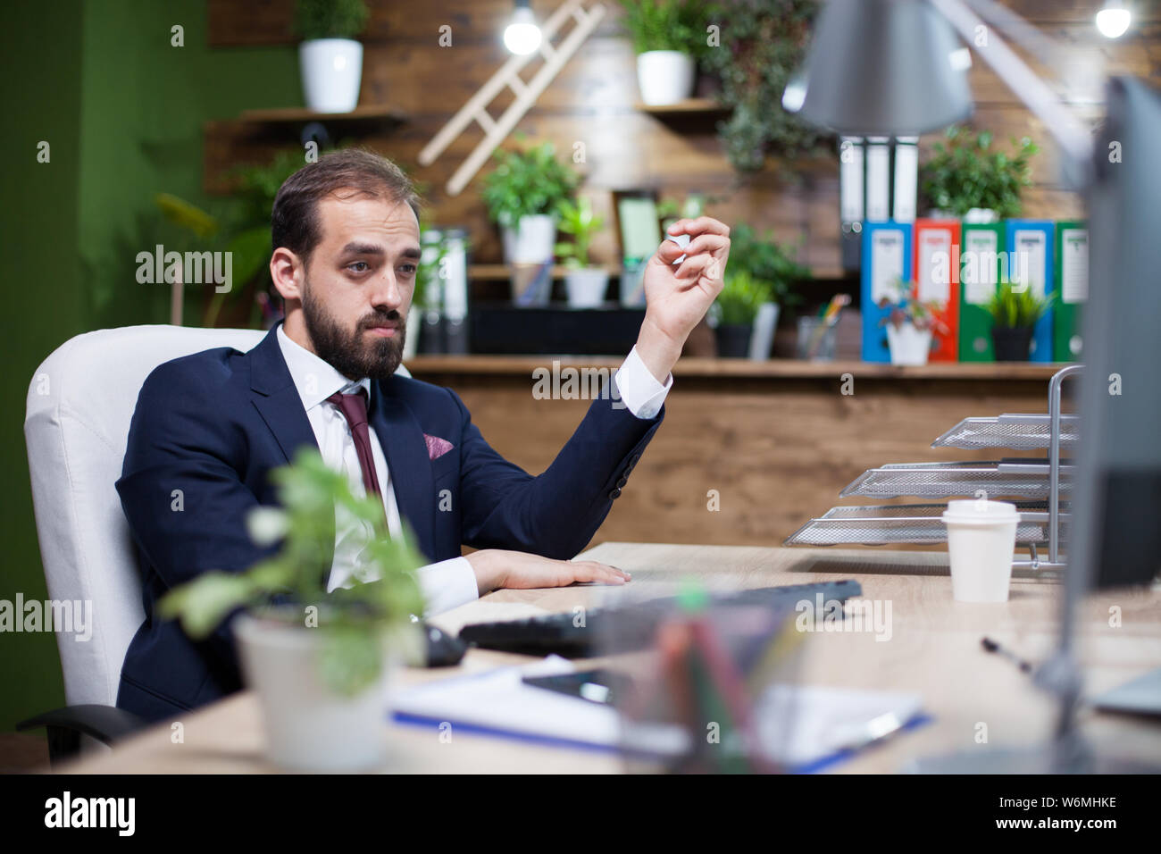 Young and elegant businessman working hard in his office. successful ...