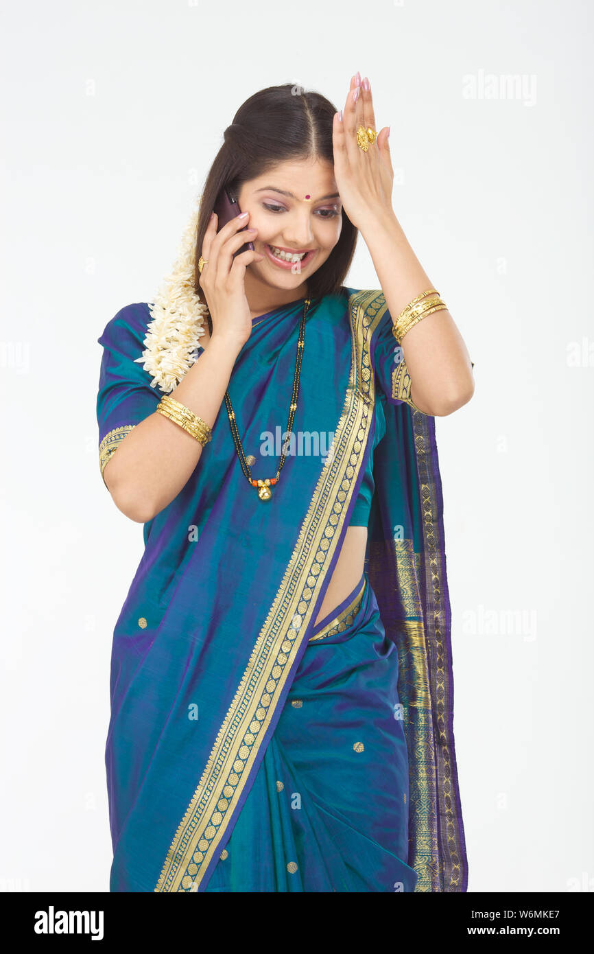 South Indian woman talking on a mobile phone and smiling Stock Photo ...