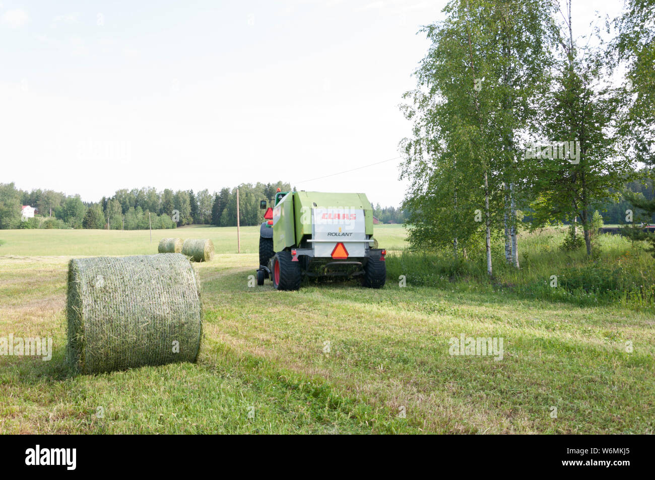 Making round bale Silage in Finland Stock Photo - Alamy