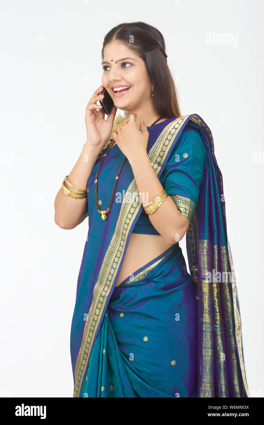 South Indian woman talking on a mobile phone and smiling Stock Photo ...