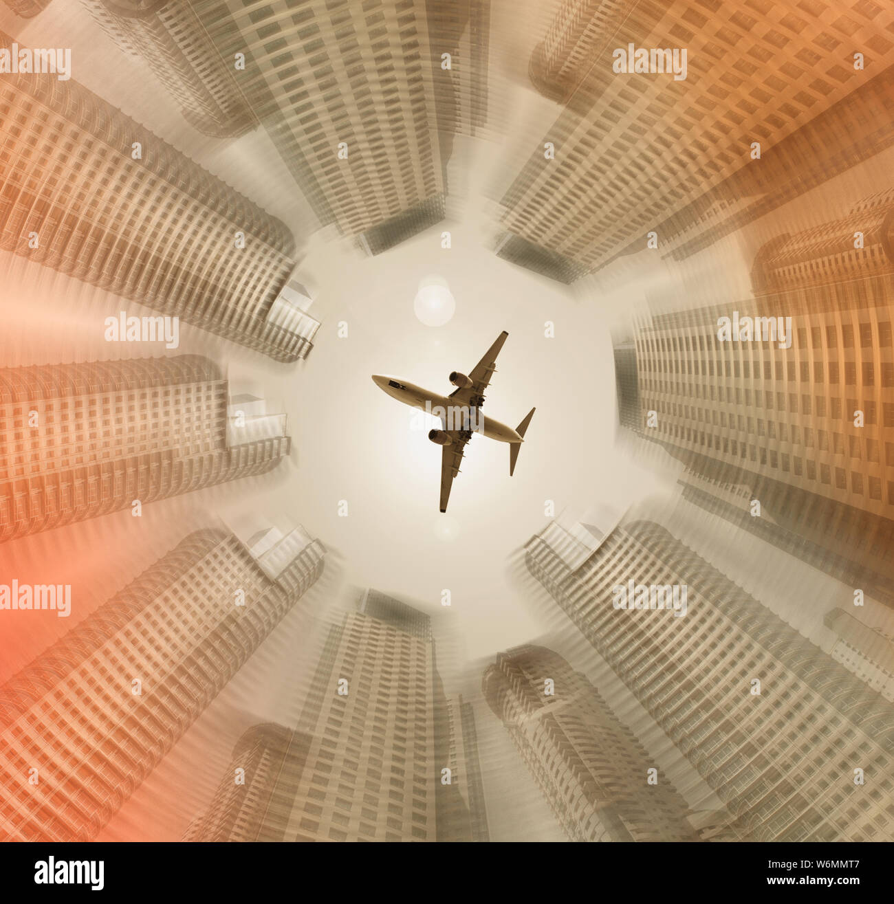Plane soaring high in the sky encircled by skyscrapers Stock Photo - Alamy