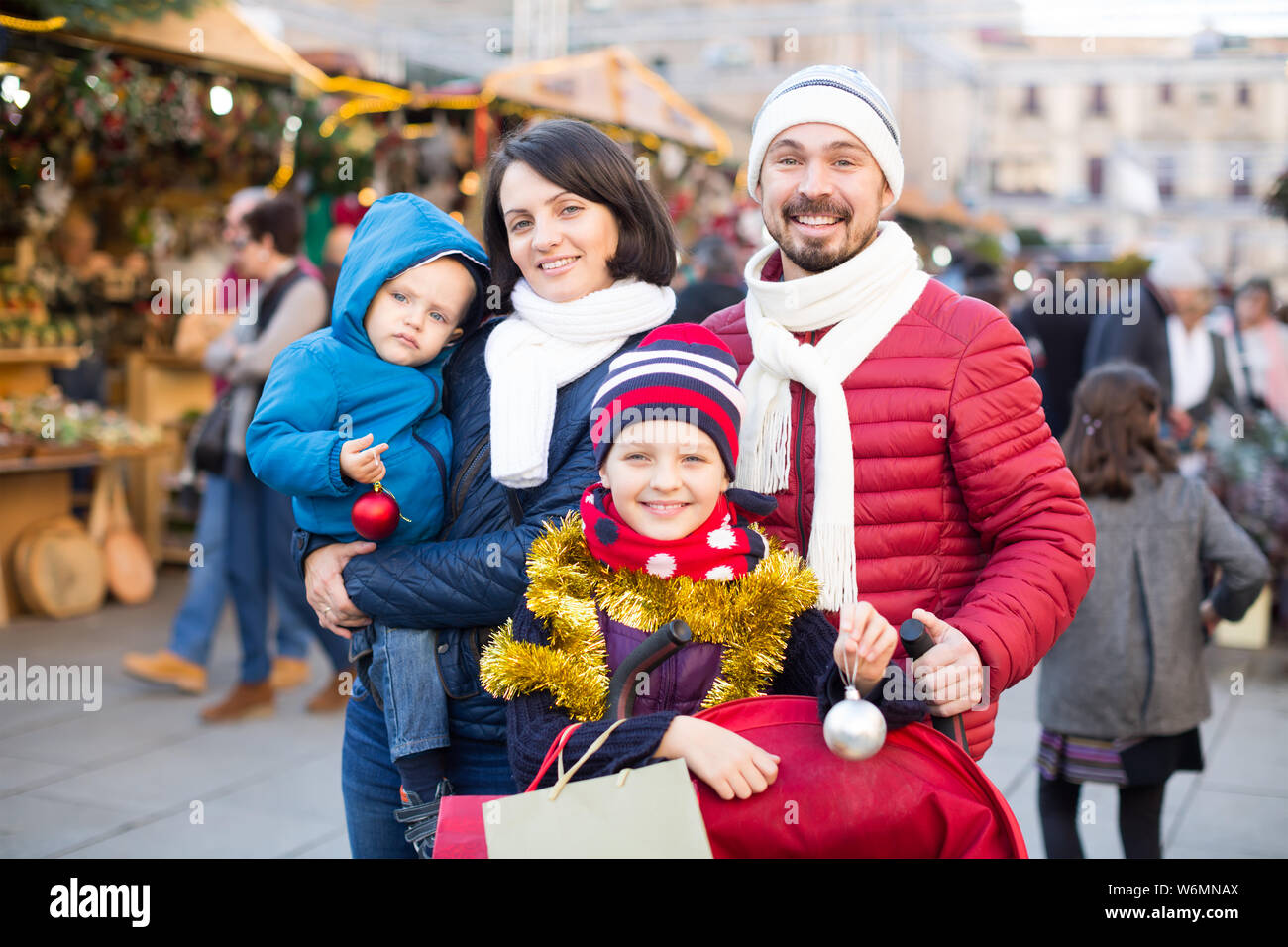 Happy parents with children customer near counter with Christmas ...