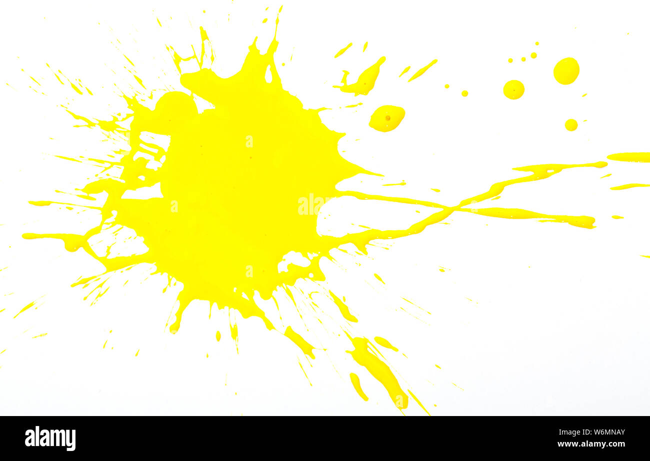 Spilled yellow paint spots on paper, colorfull artistic image on white ...