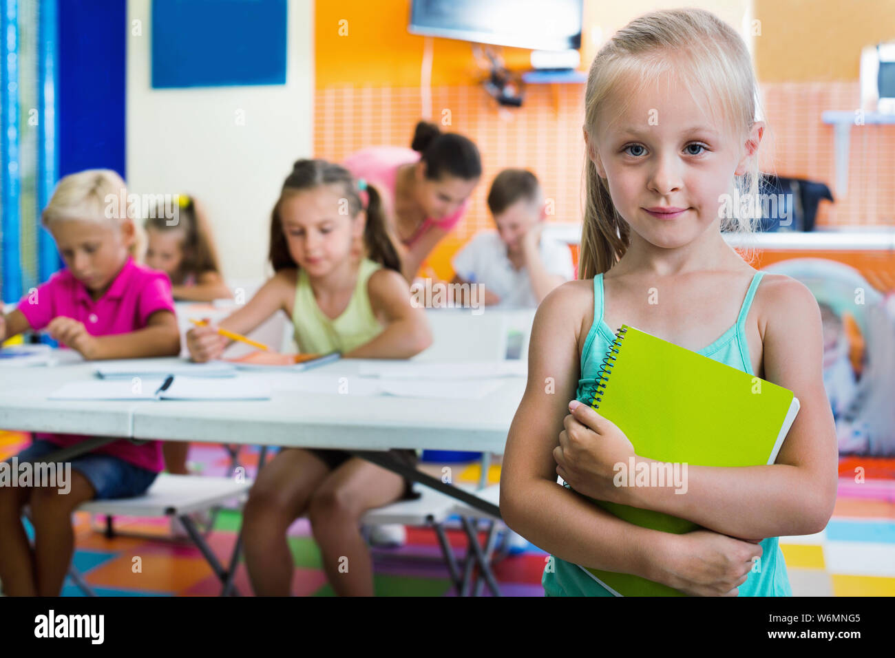 Portrait of cheerful pretty pupil girl studying in school class Stock ...