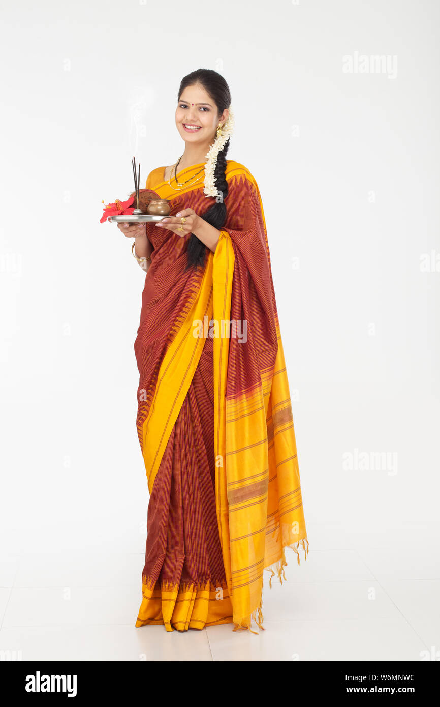 South Indian woman holding puja thali and smiling Stock Photo - Alamy