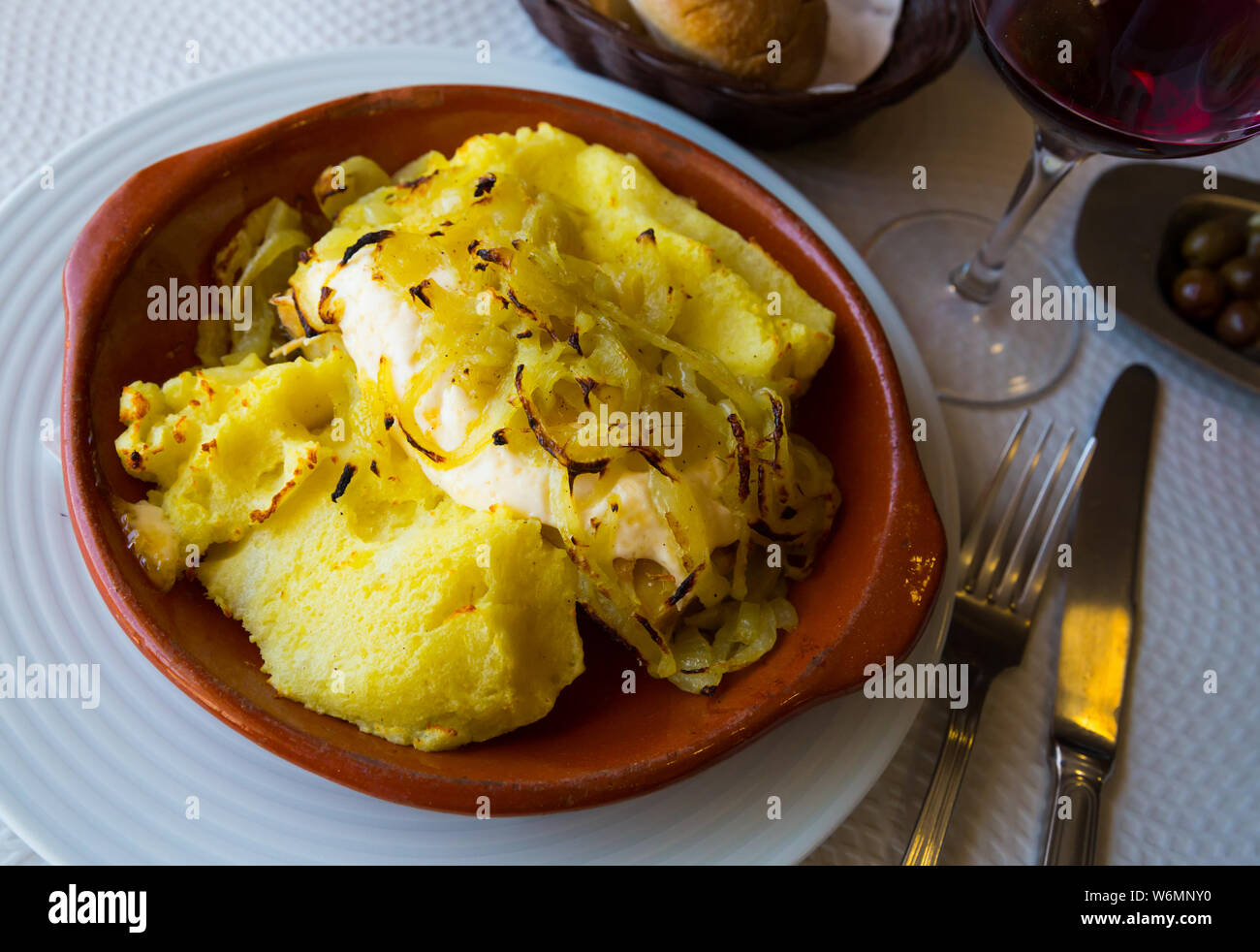Healthy dinner, cod steak baked with potato and onion Stock Photo - Alamy