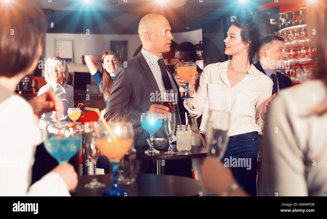 Glad positive smiling male and female colleagues having fun on ...