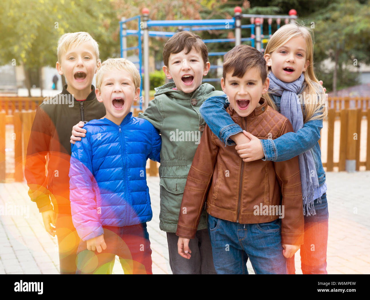 Portrait of happy kids standing together on playground in autumn day ...