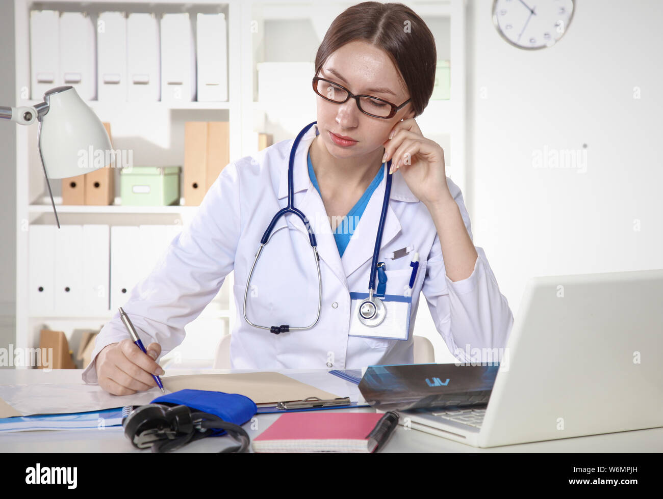 Young woman doctor examines the X-rays. Isolate Stock Photo - Alamy