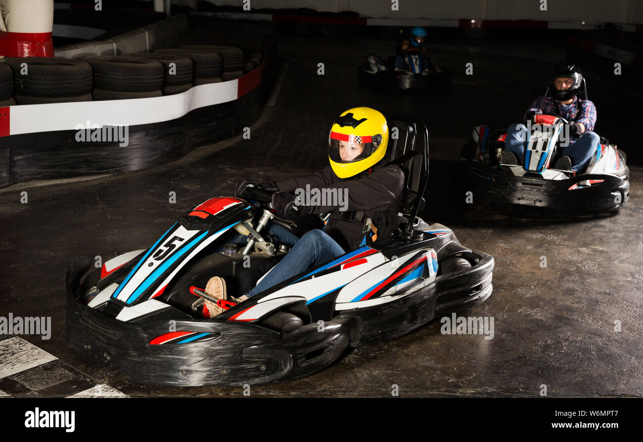 Portrait of young woman driving racing car at kart circuit Stock Photo ...