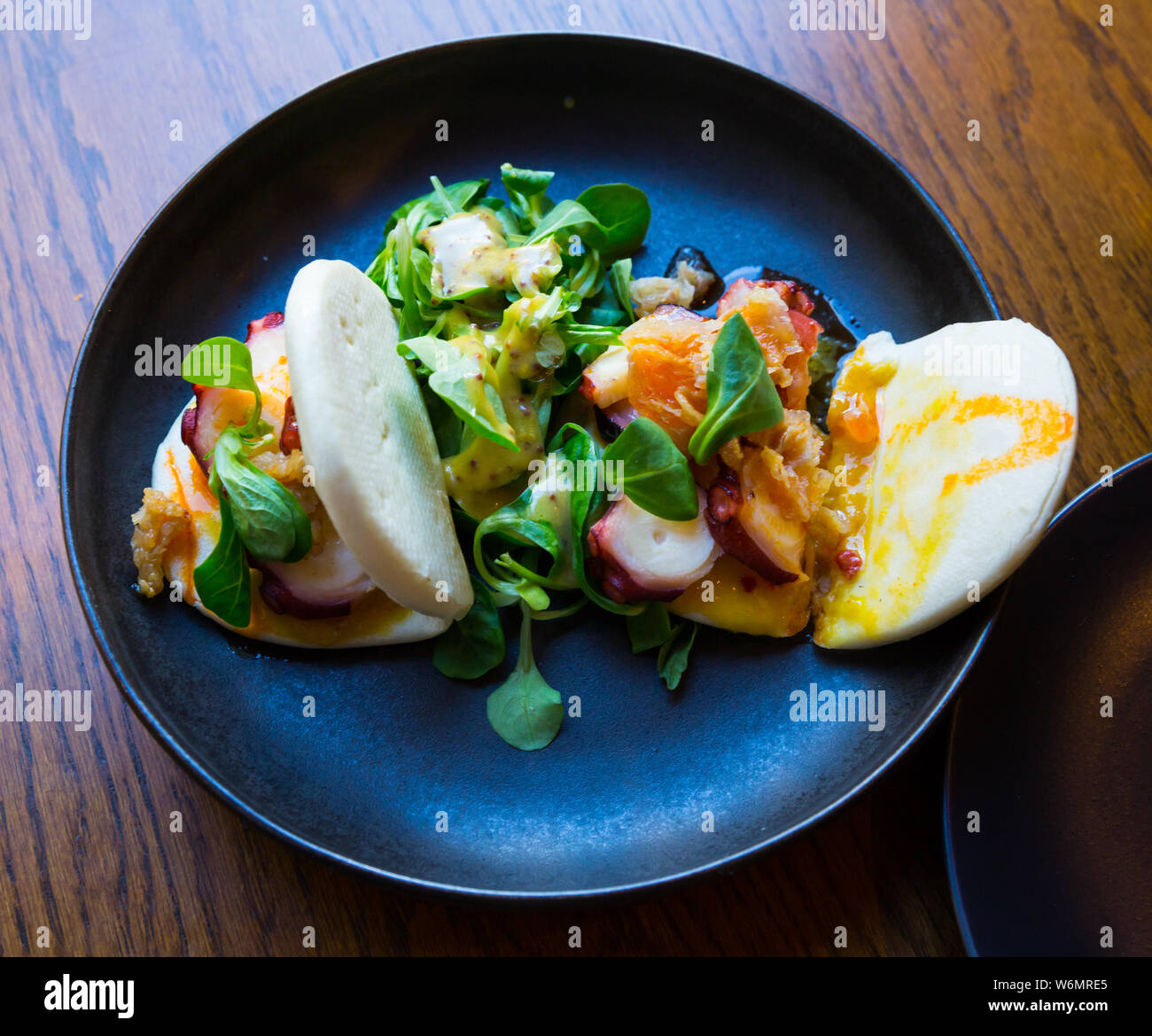 Baozi with sliced octopus tentacles with piquant Indian mango and bacon ...