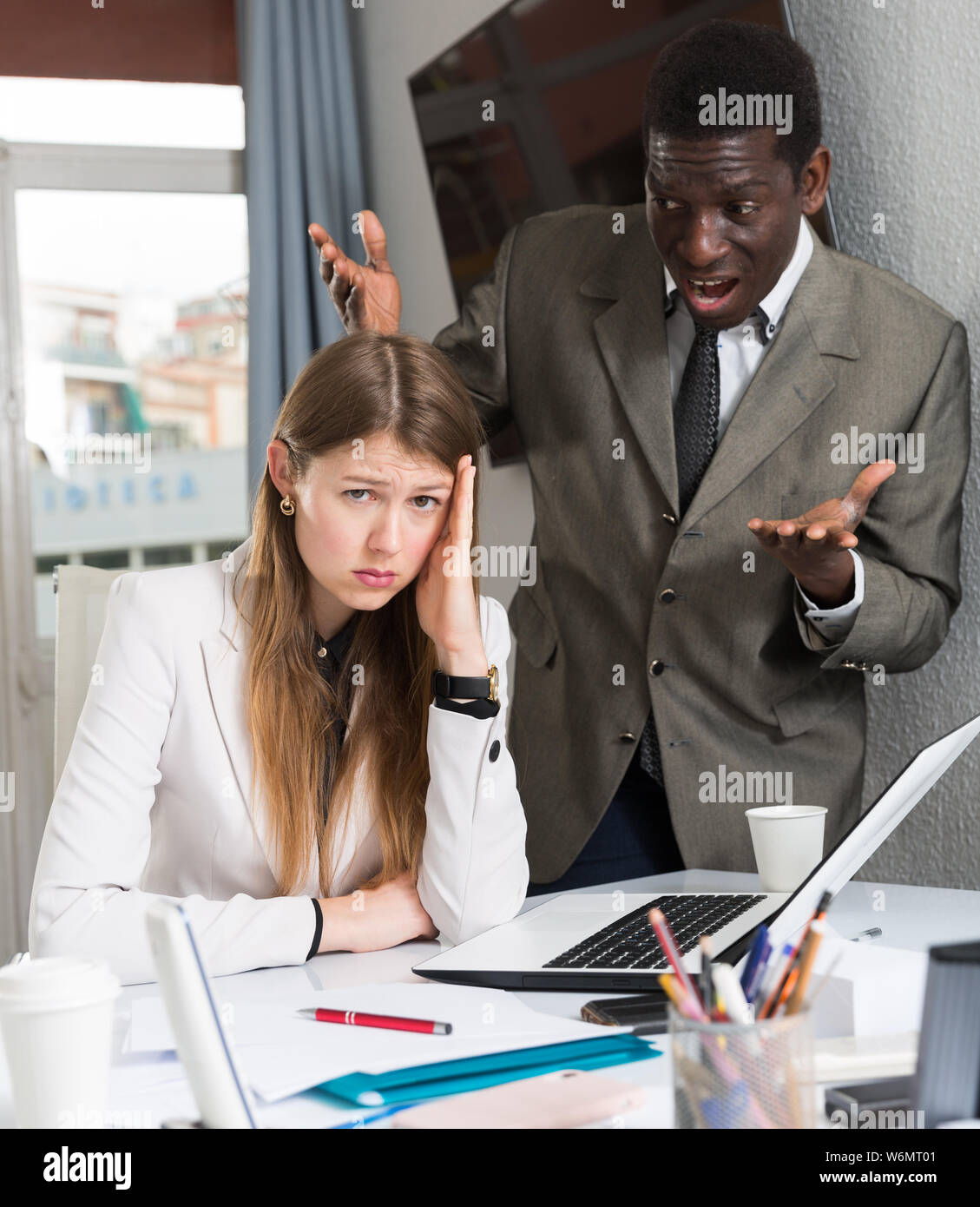 Boss sitting behind desk standing hi-res stock photography and images ...